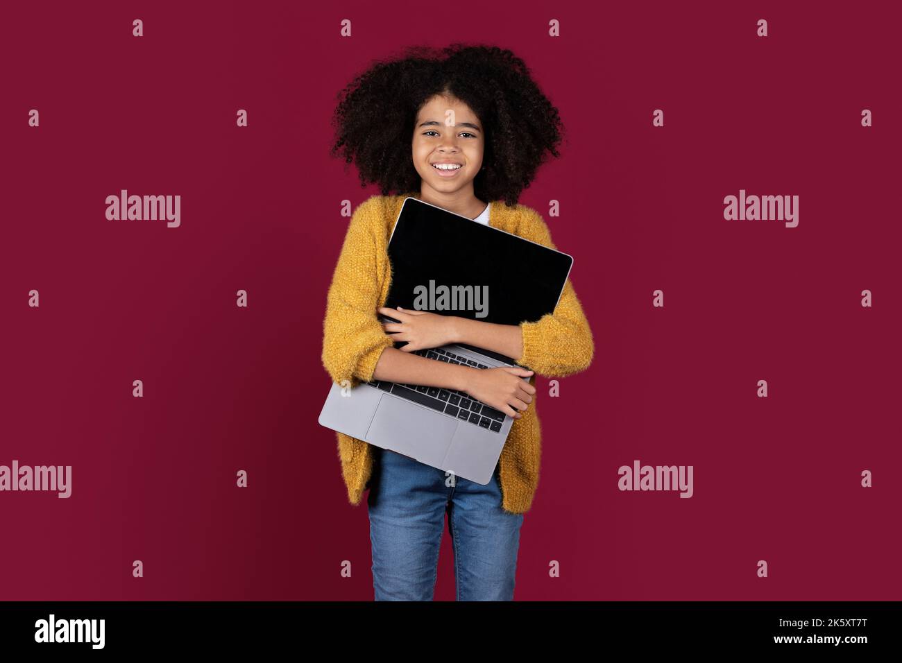 Happy black kid embracing modern laptop on colorful background Stock ...