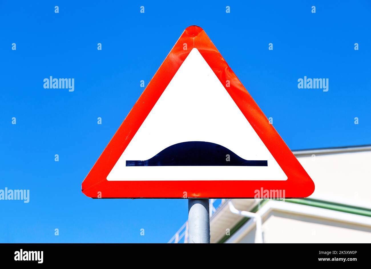 Triangle speed bump road sign against the blue sky. Warning traffic sign Speed bump Stock Photo ...