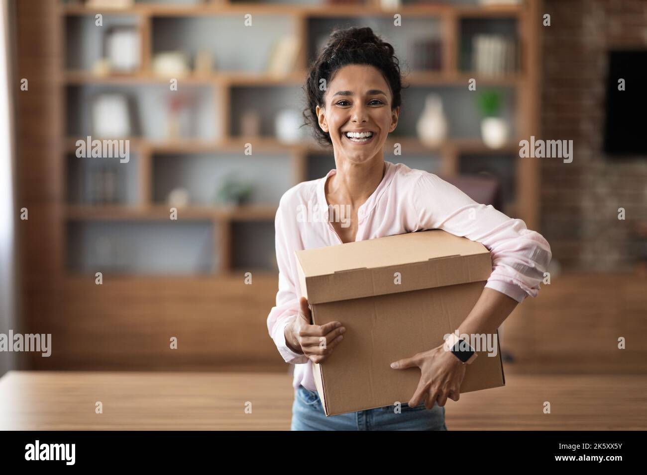 Young woman embracing gift hi-res stock photography and images - Alamy