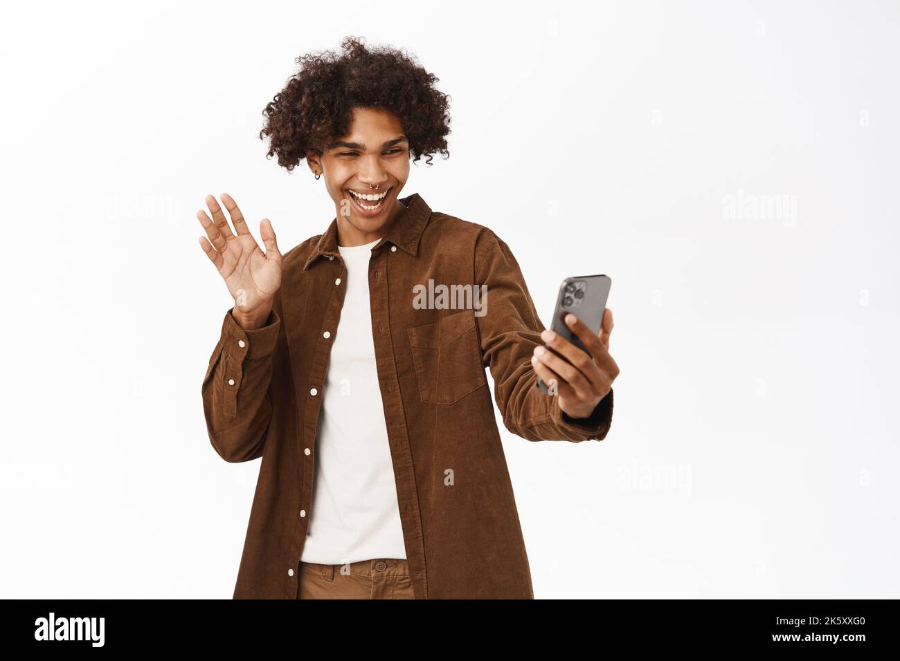 Portrait of handsome boy video chat, talking on mobile phone ...