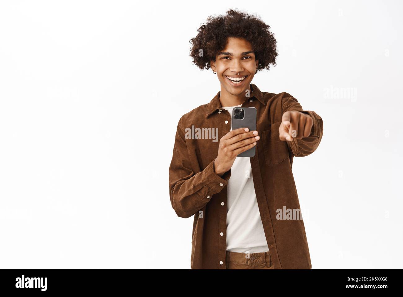 Portrait of gen-z guy pointing at camera, recording video or taking ...
