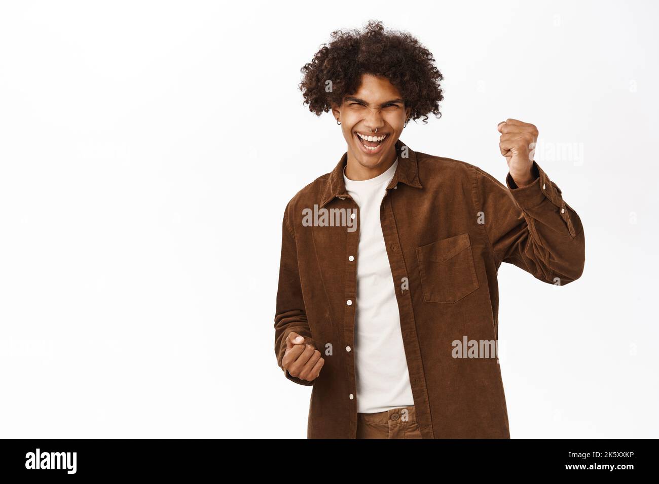 Happy guy triumphing and celebrating, saying yes with ecstatic face ...