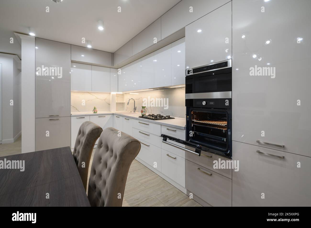 Huge white luxury kitchen in a studio apartment interior Stock Photo ...