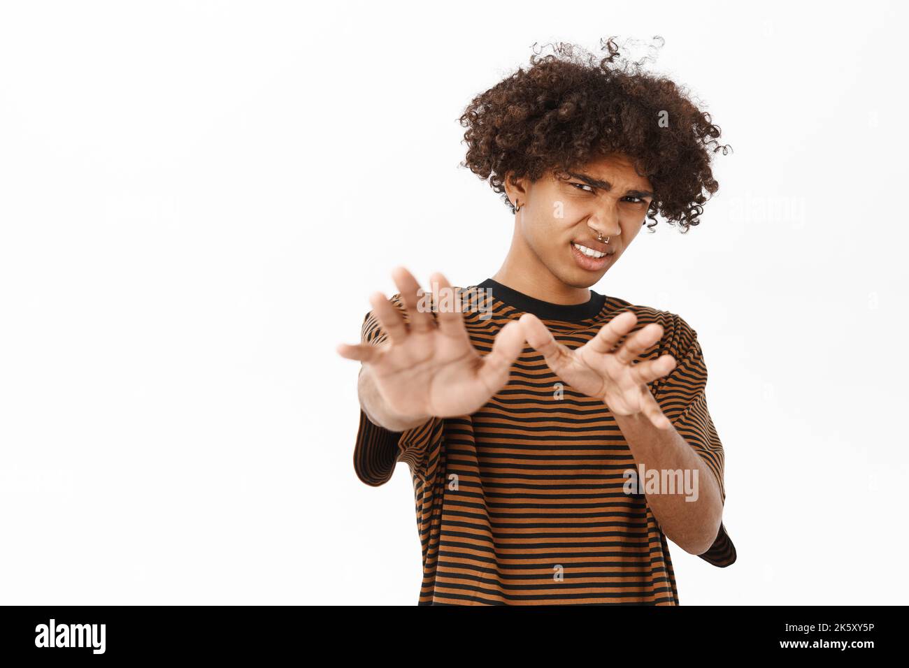 Portrait of guy showing stop, refusal gesture, rejecting smth with ...