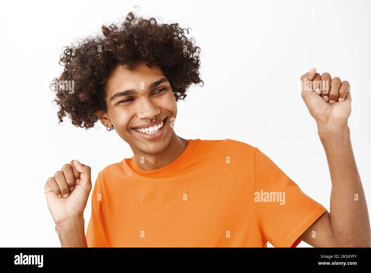 Close up of handsome hispanic guy dancing and smiling, enjoying party ...
