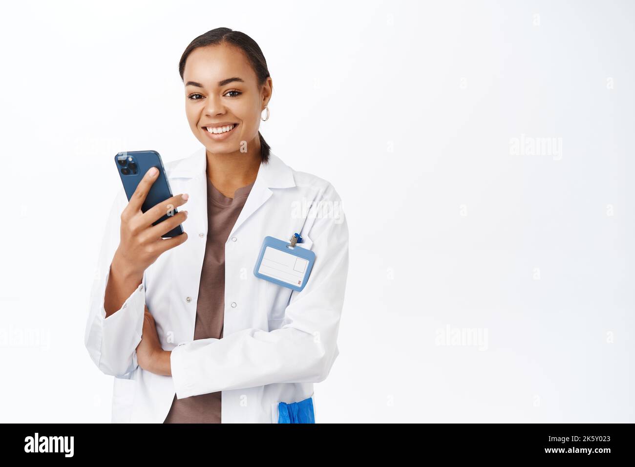 Online medical help. Young female doctor, therapist holding mobile ...