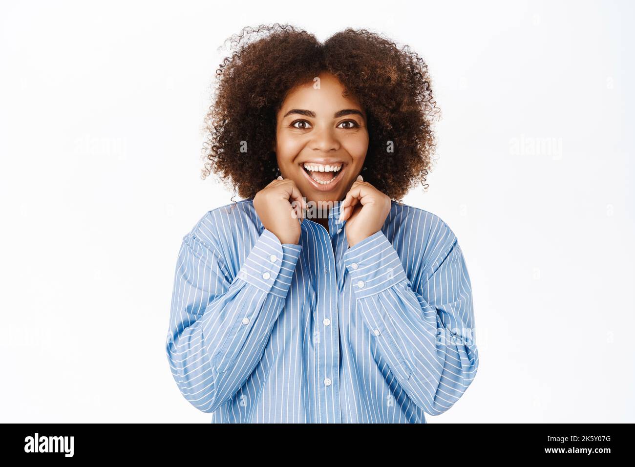 Excited african american young woman, looking amazed and fascinated ...