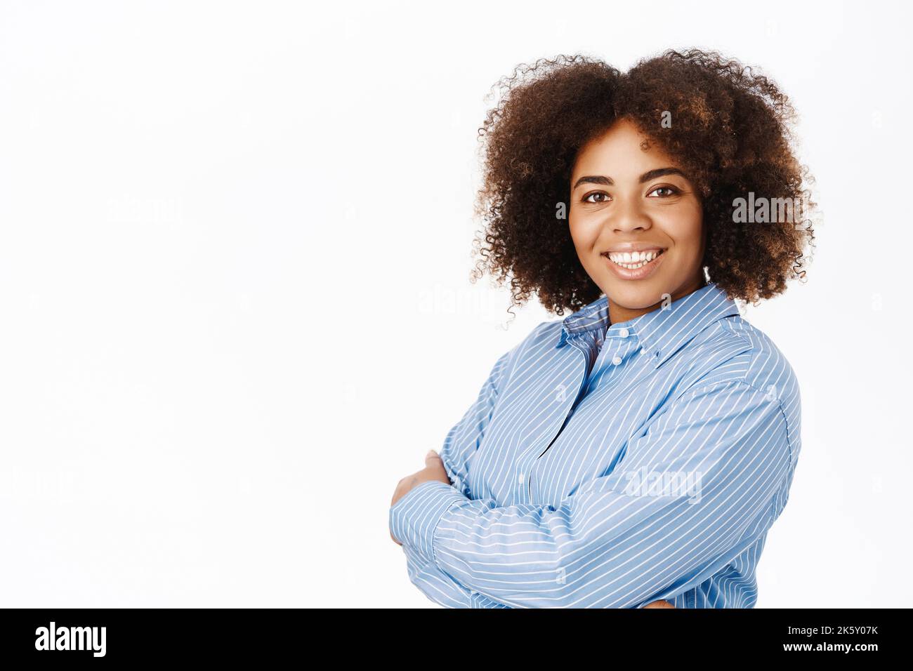 Portrait of young ambitious african american woman, cross arms on chest ...