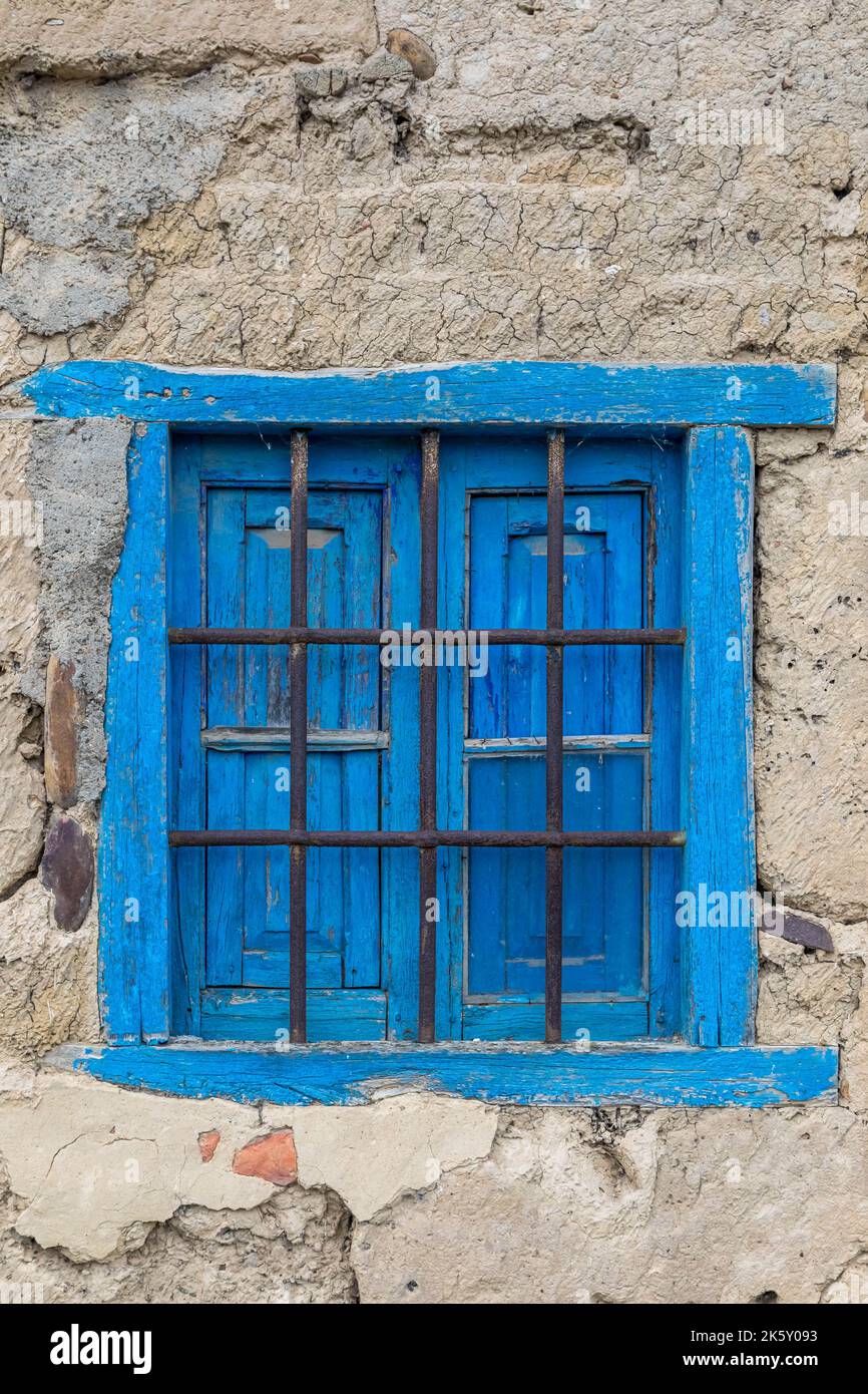 Stone wall with blue window Stock Photo - Alamy