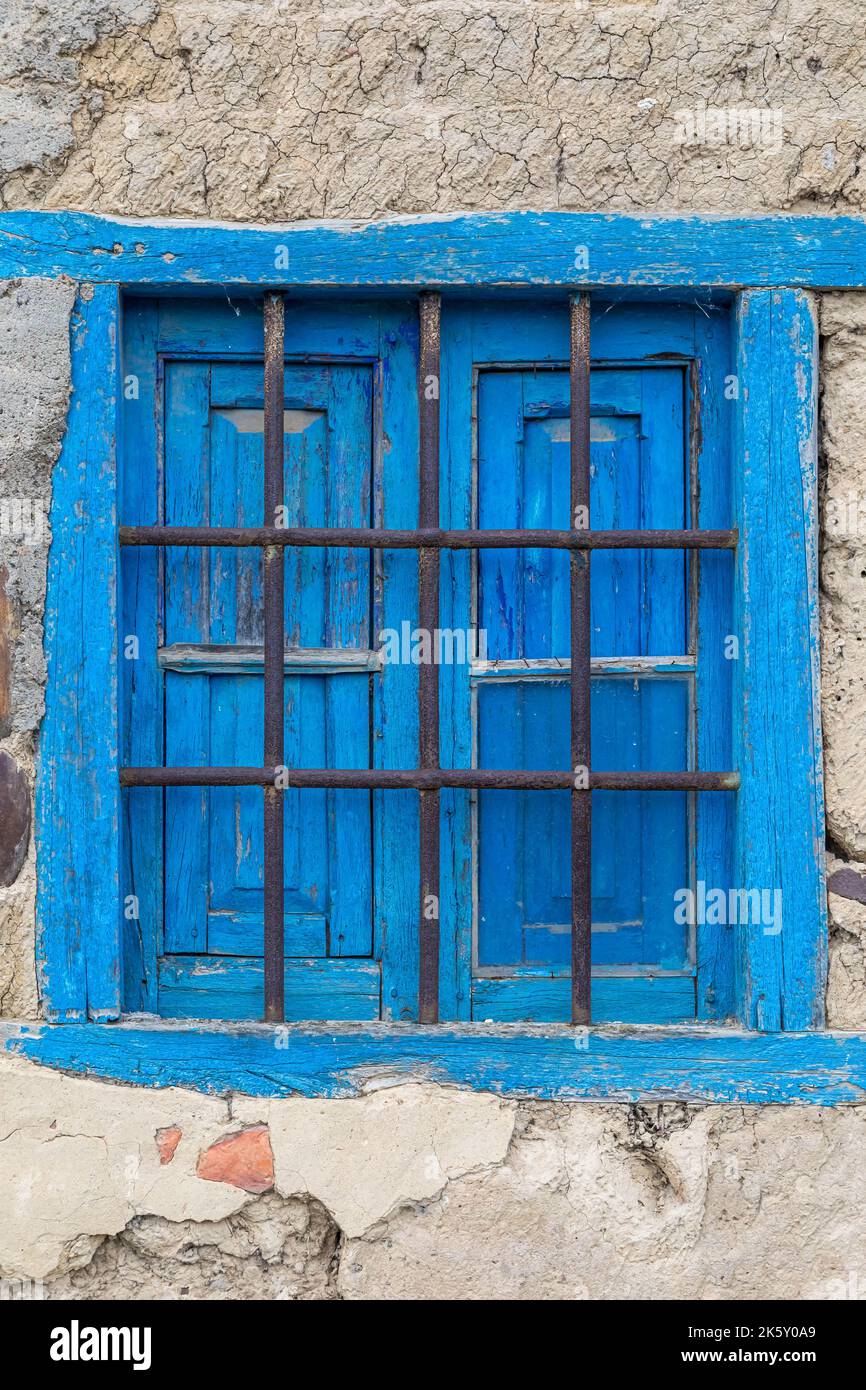 Stone wall with blue window Stock Photo - Alamy