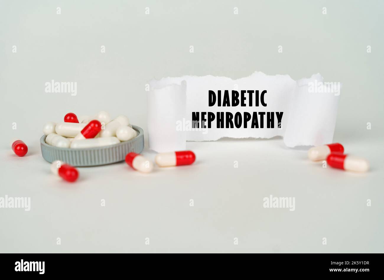 Medical concept. On a gray background, medical capsules and a paper ...