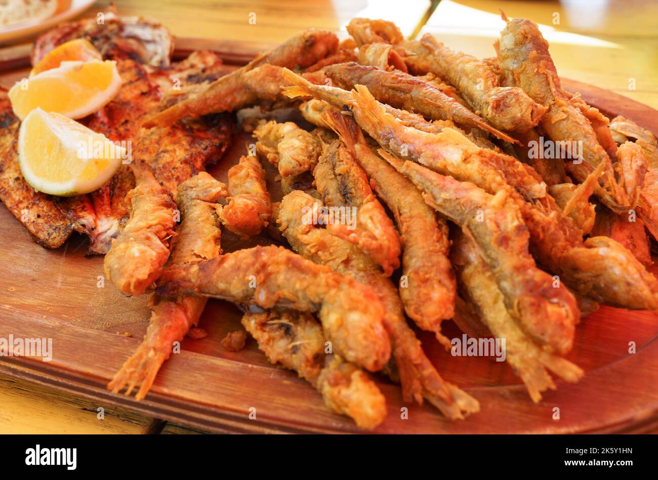 Plate of fried small fish red mullet and lemon. Close up Stock Photo ...