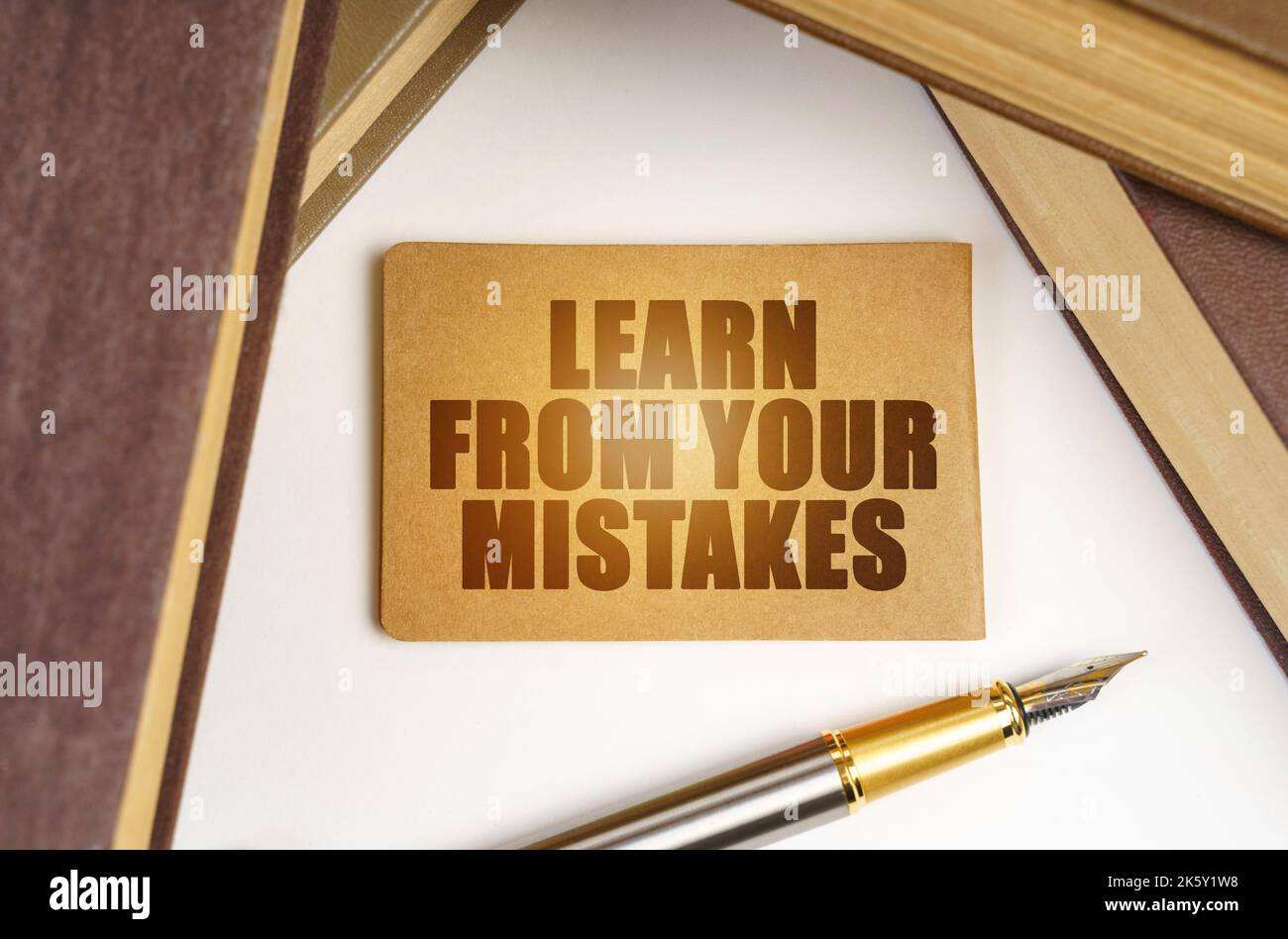 Education and business concept. Next to the books lies a pen and a sign ...