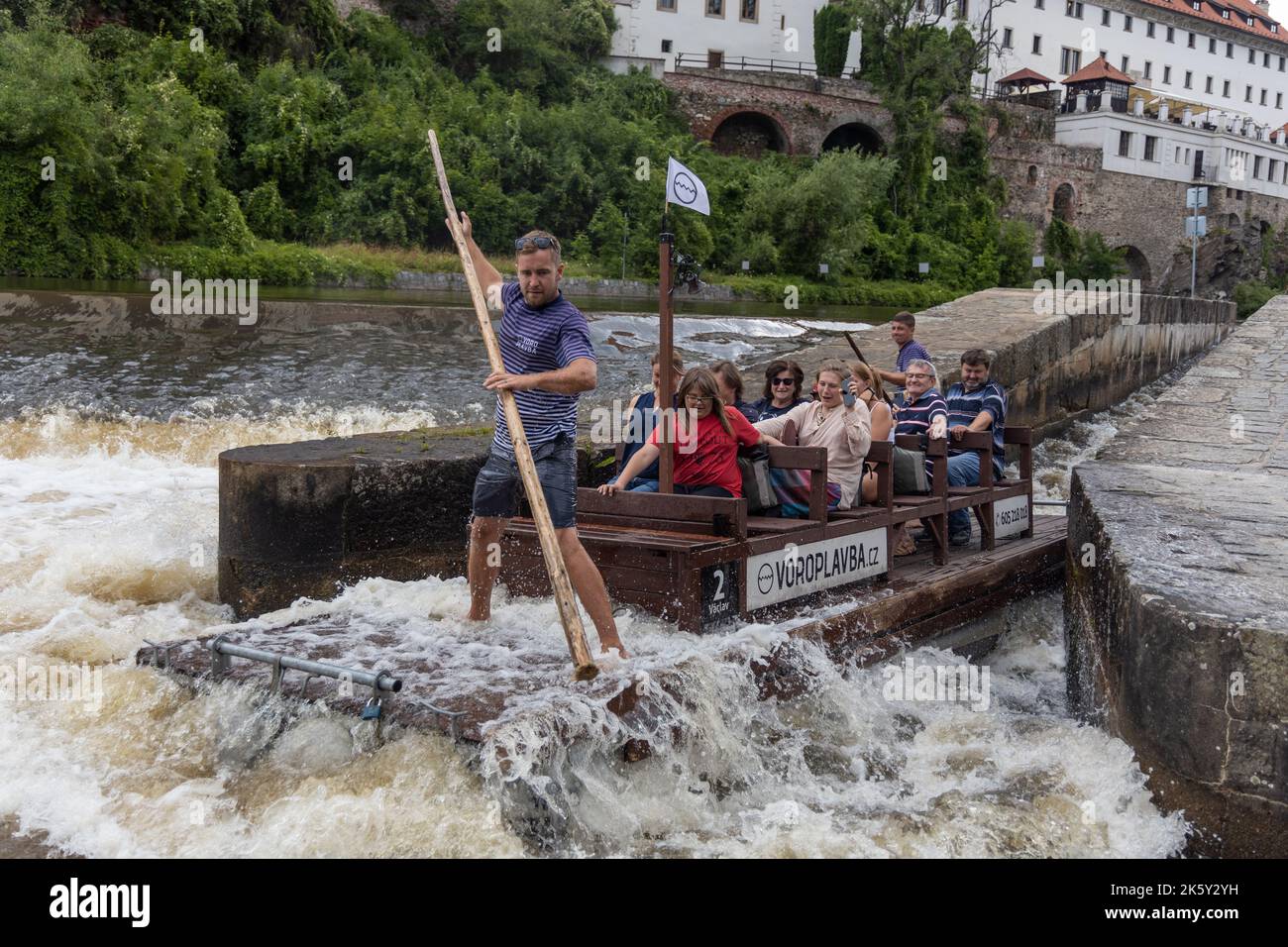 People on wooden raft (vor) on Vltava river in the historical town of ...