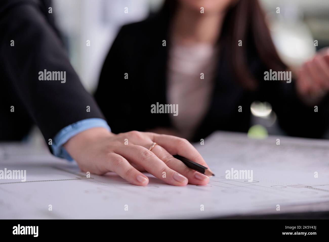 Architects working on cad project, hand with pencil on blueprint ...