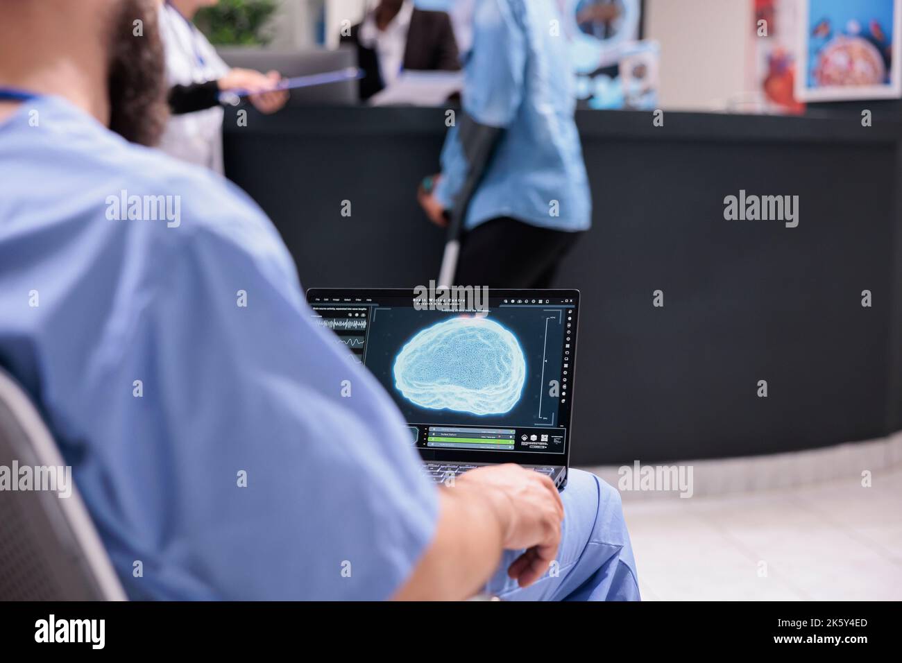 Expert neurologist studying brain image on laptop at neurology clinic ...