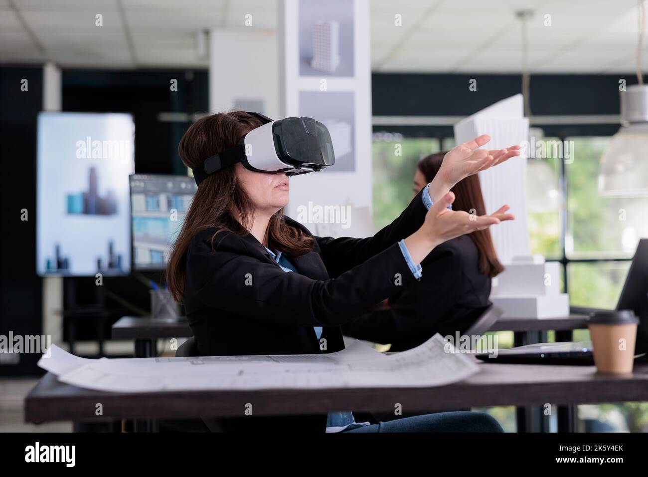 Architect wearing vr headset designing in metaverse, touching virtual ...