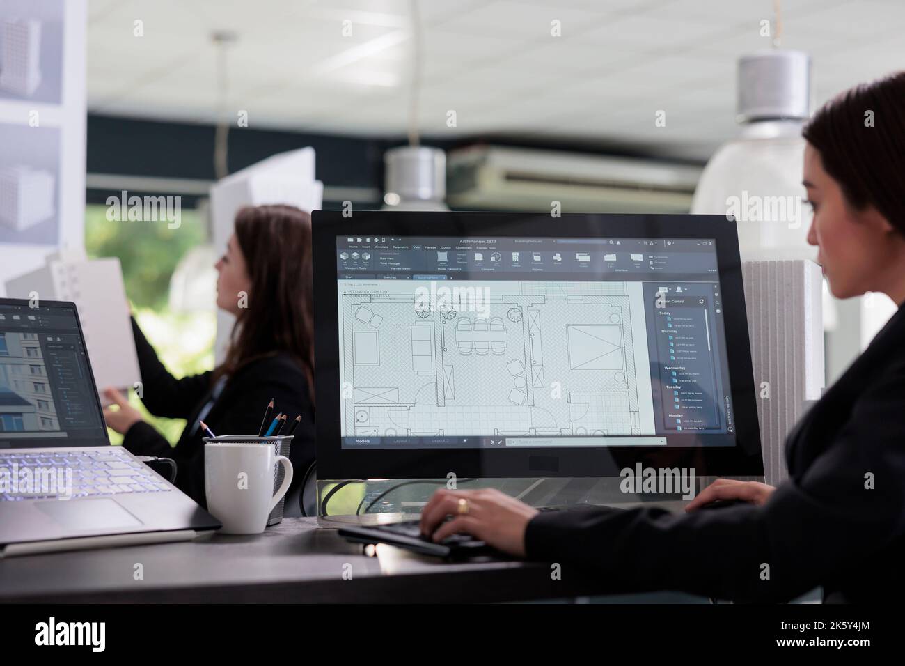 Real estate agent working in floor planner software, blueprints, home ...