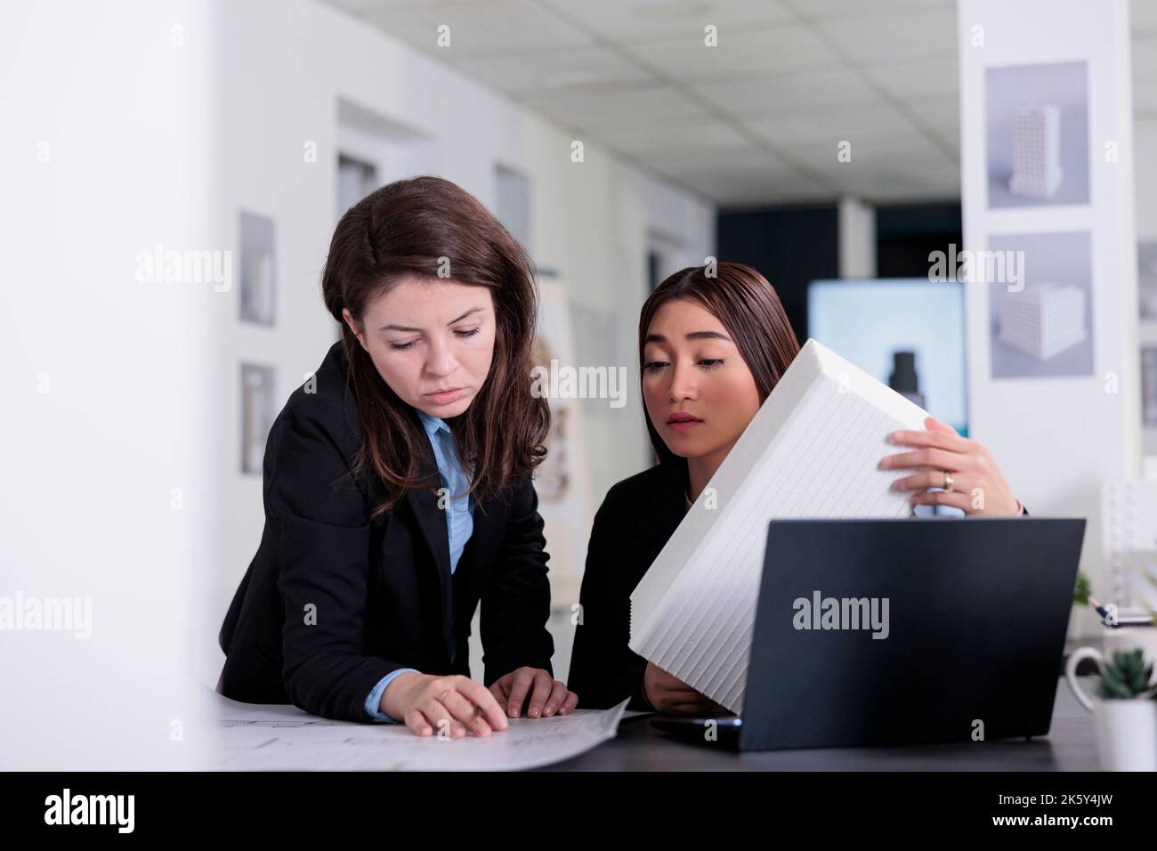 Architects Working With Blueprints Looking At Project Draft Discussing Architectural 3d Model