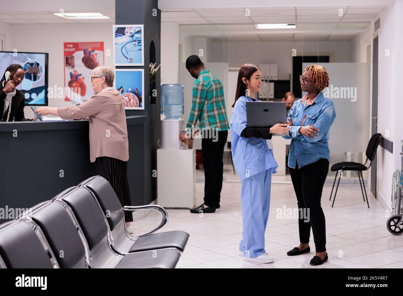 Cardiovascular care institute busy reception area. Asian nurse ...