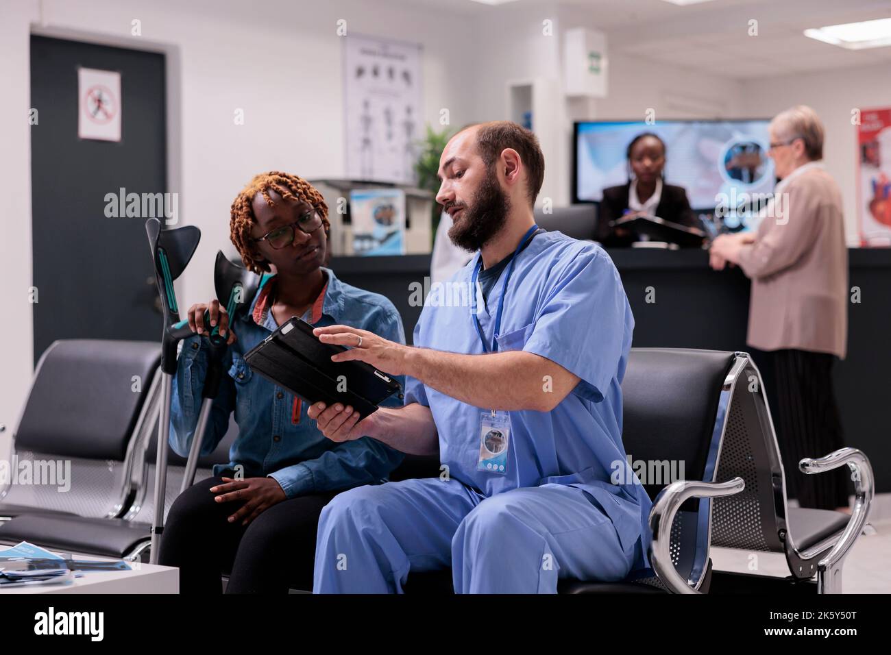 African american woman looking images of injuries on tablet. Physician ...