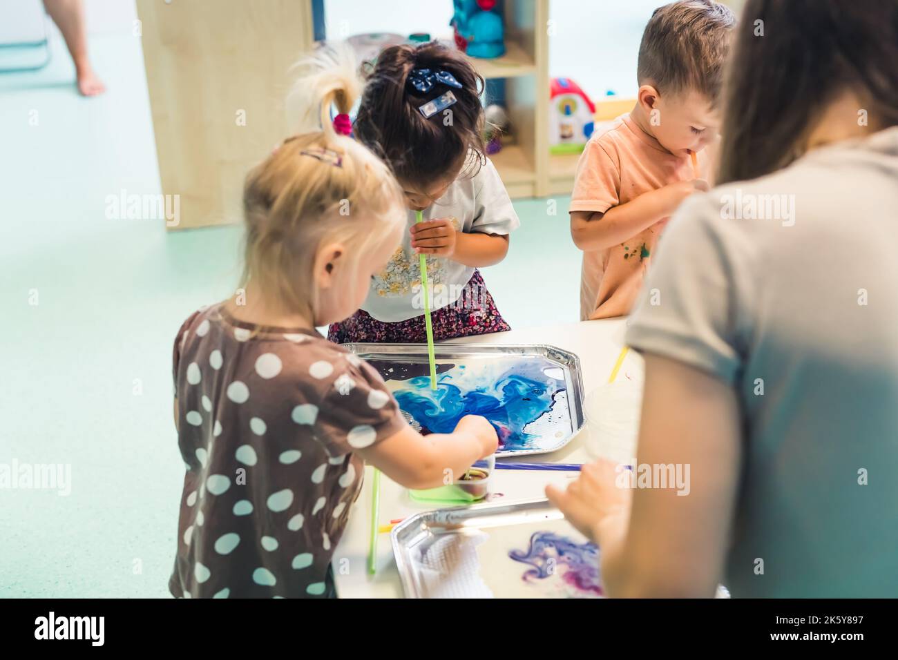 kids blowing into the small tubes in order to paint with watercolors in ...