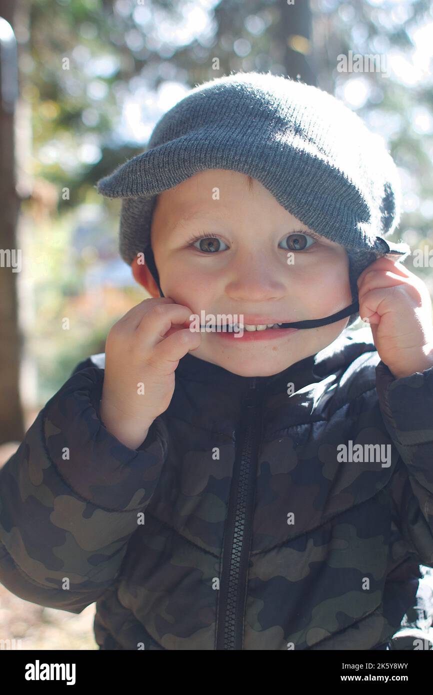 Baby boy bite his hat Stock Photo - Alamy