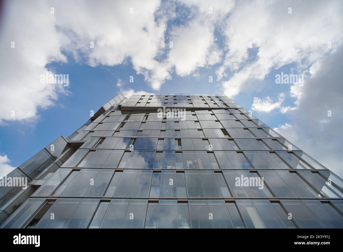 Windows reflecting in a high rise building with clouds Stock Photo - Alamy