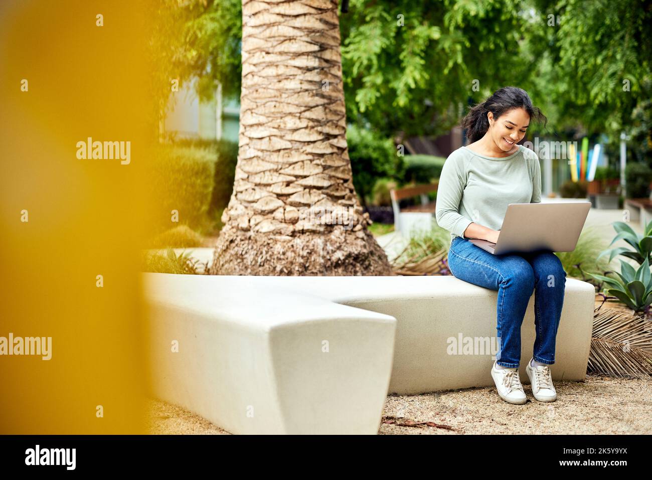 Teen on bench with laptop hi-res stock photography and images - Alamy