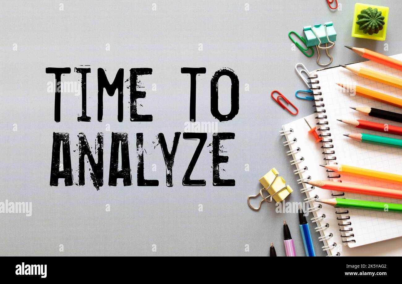 TIME TO ANALYZE text on paper with calculator,magnifier ,pen on the ...