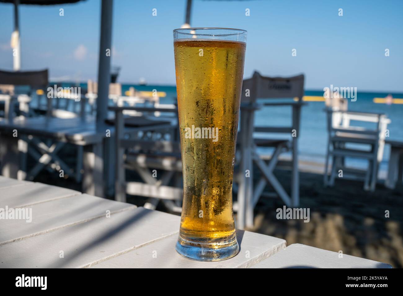 Pint of cold lager beer served outdoor in sunny beach bar on Cyprus ...