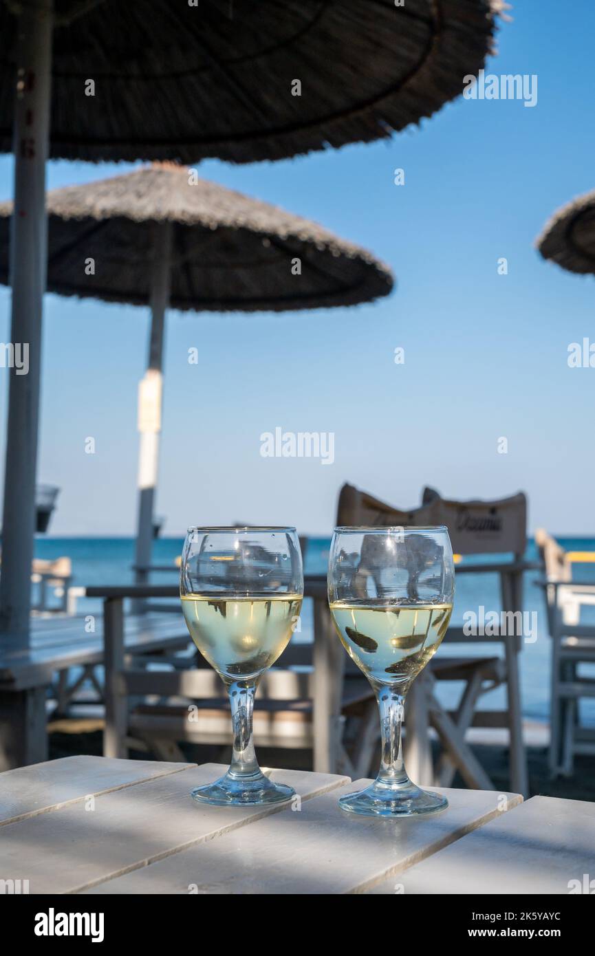 Drinking of cold white wine in beach bar, summer holidays, relax on ...