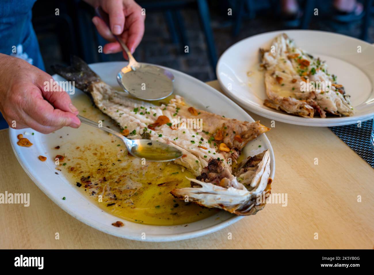 Serving in restaurant of fresh grilled with garlic and olive oil on old ...