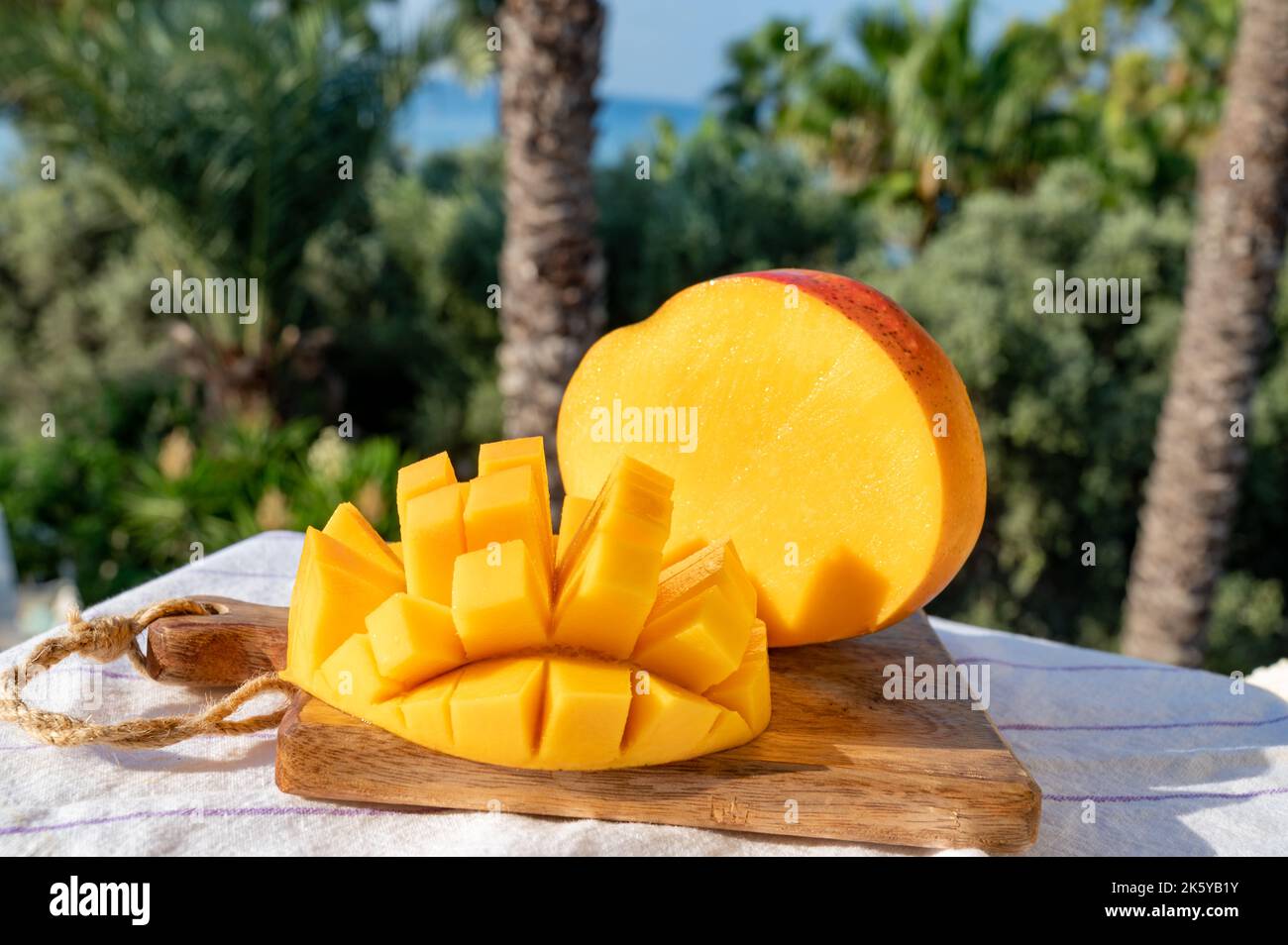 Fresh ripe sweet yellow mango tropical fruit served outdoor with view ...