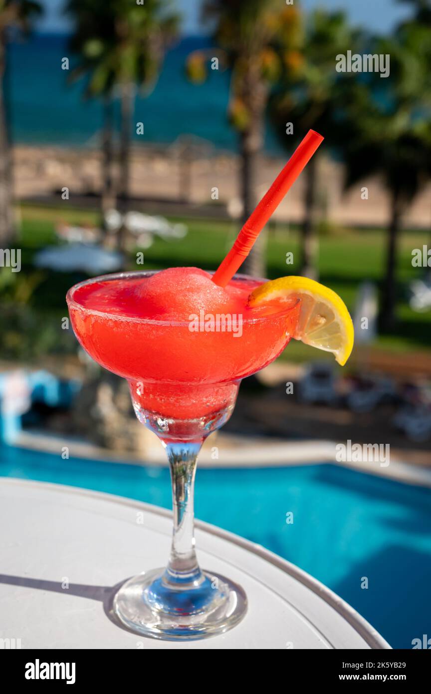 Colourful frozen pink Strawberry daiquiri cocktail drink served in ...