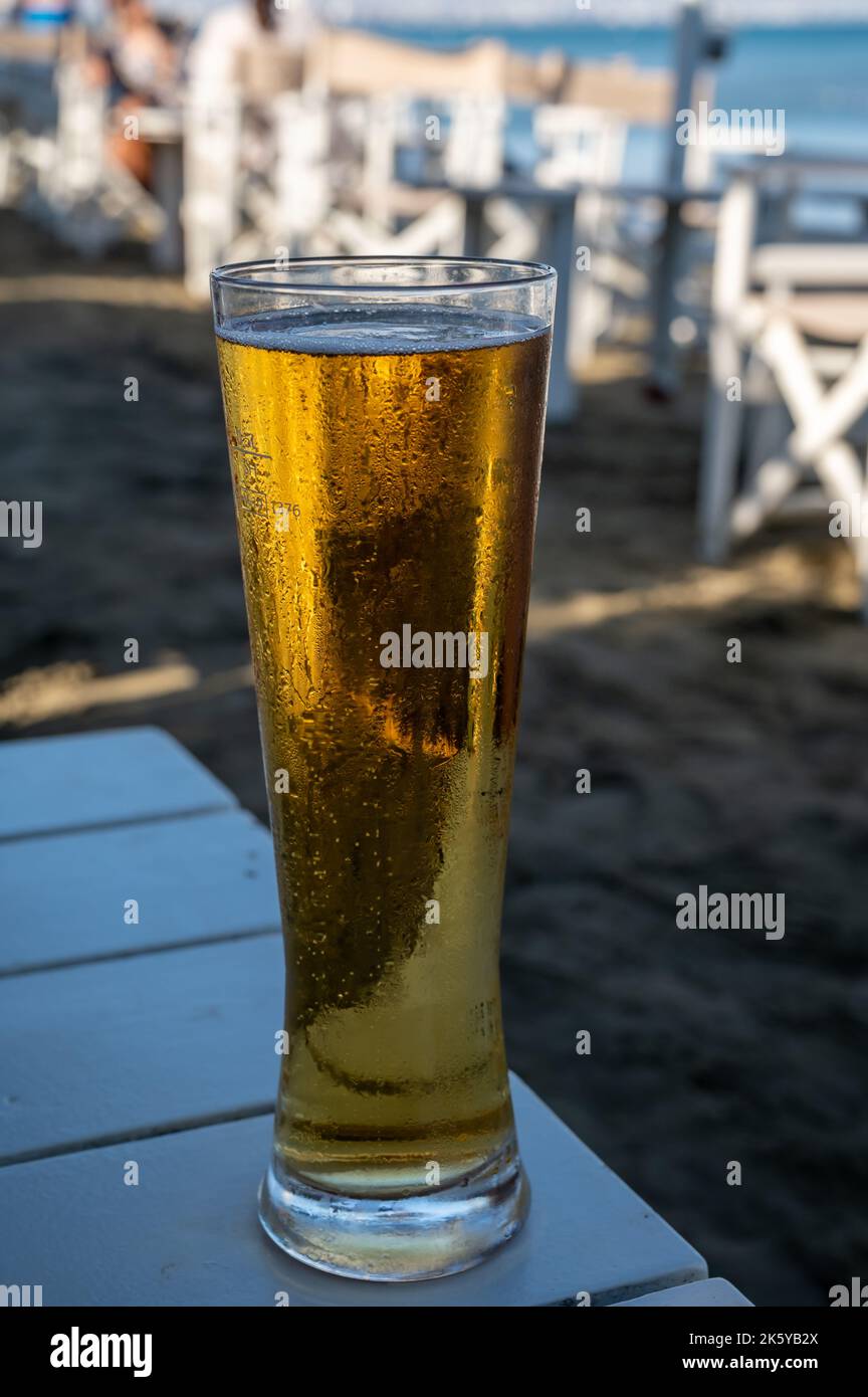 Pint of cold lager beer served outdoor in sunny beach bar on Cyprus ...