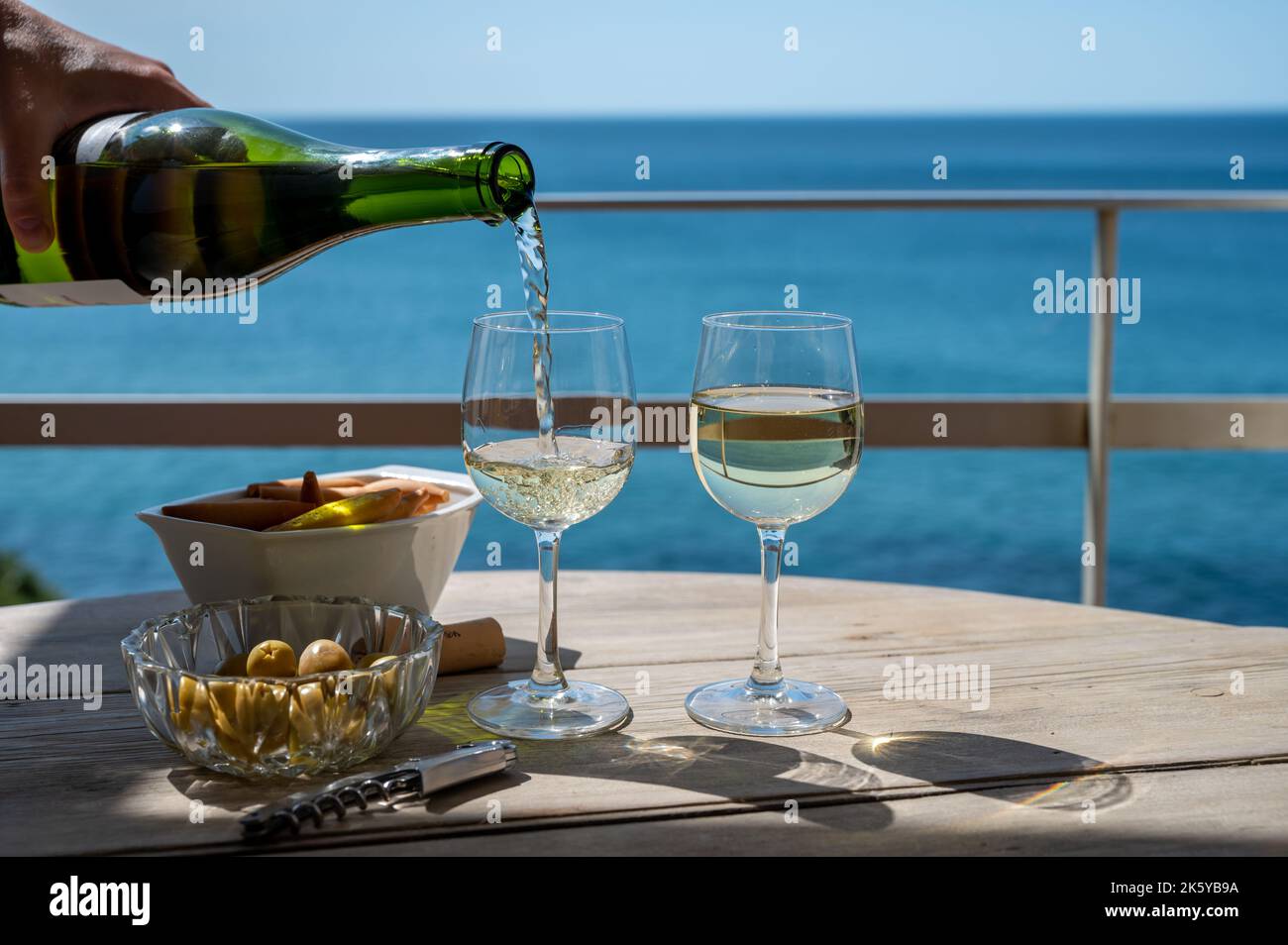 Pouring of txakoli or chacolí slightly sparkling very dry white wine ...