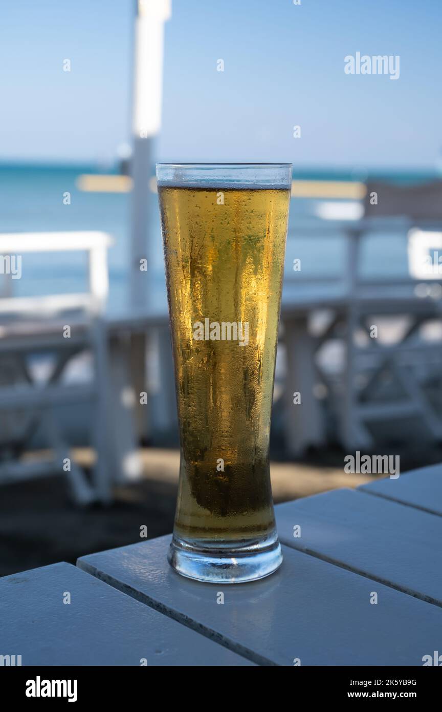 Pint of cold lager beer served outdoor in sunny beach bar on Cyprus ...