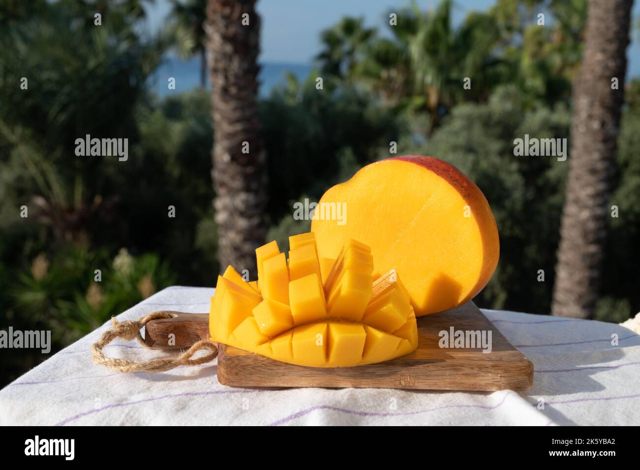 Fresh ripe sweet yellow mango tropical fruit served outdoor with view ...