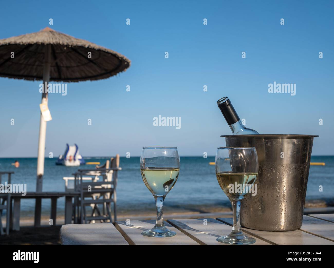 Drinking of cold white wine in beach bar, summer holidays, relax on ...