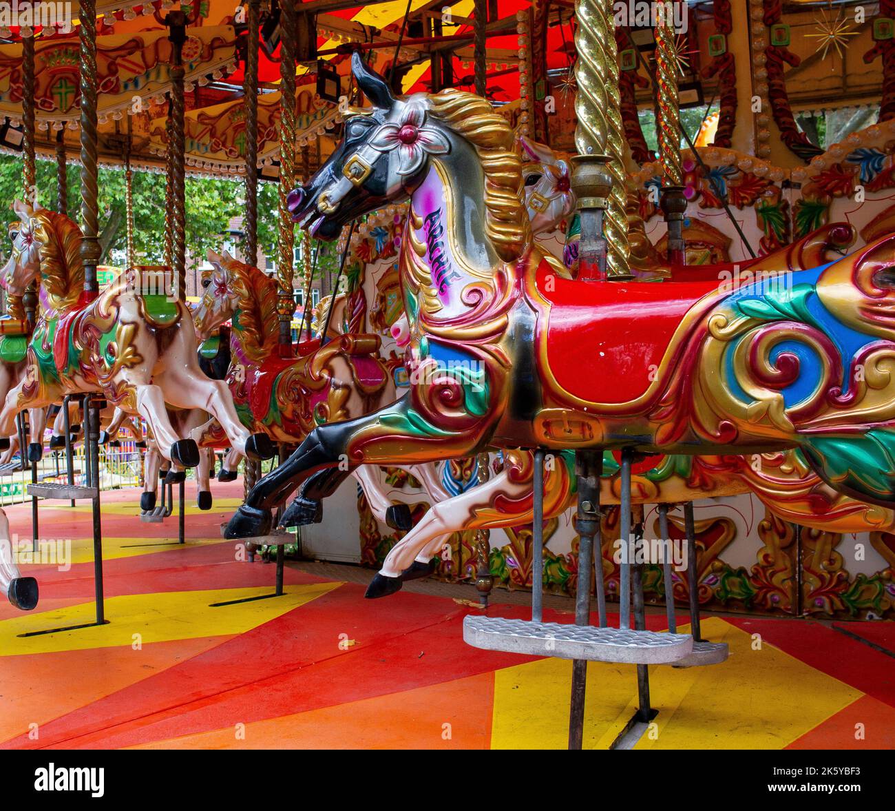 Fairground at Parsons Green, West London, UK; super-bright coloured ...