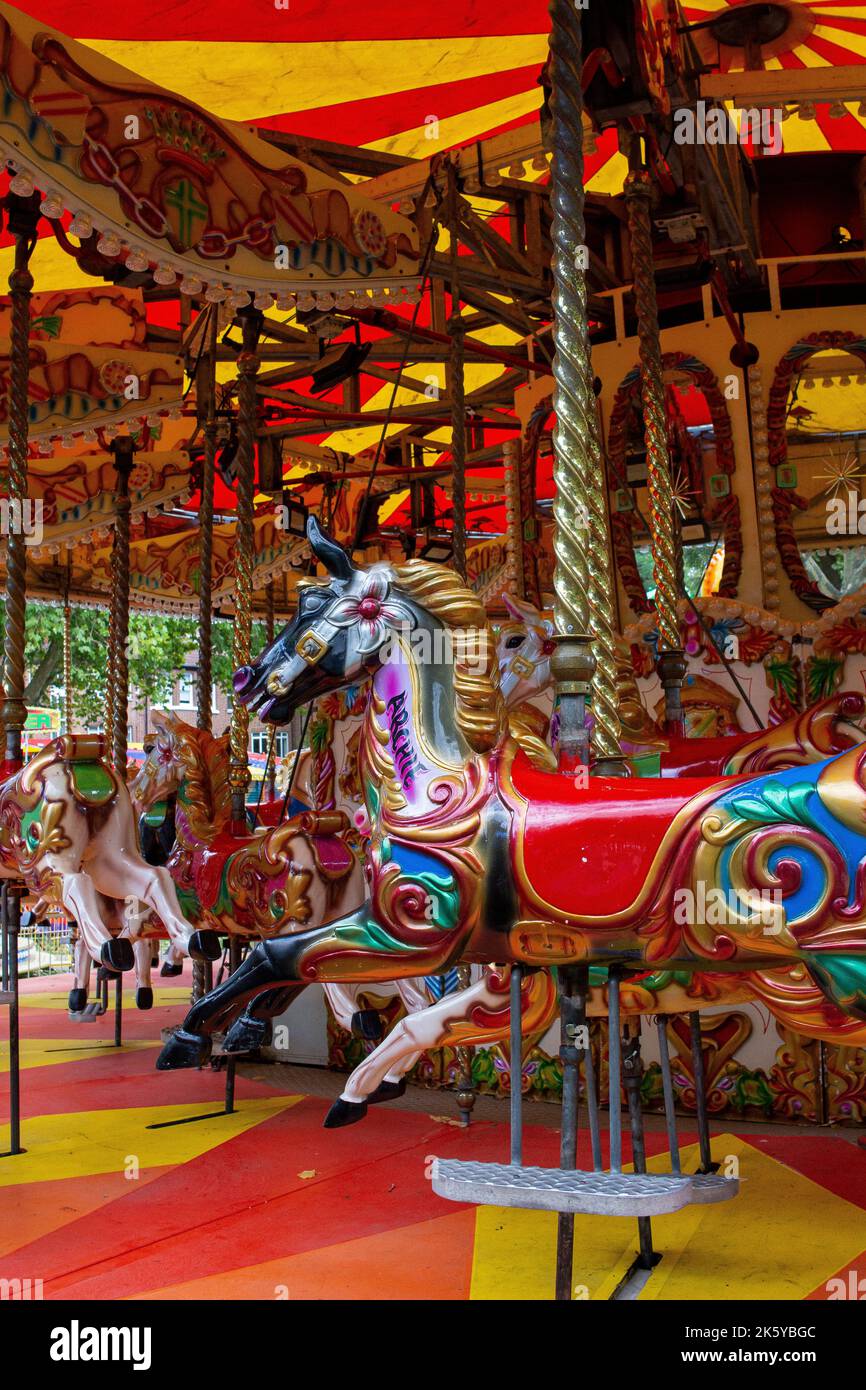 Fairground at Parsons Green, West London, UK; super-bright coloured ...