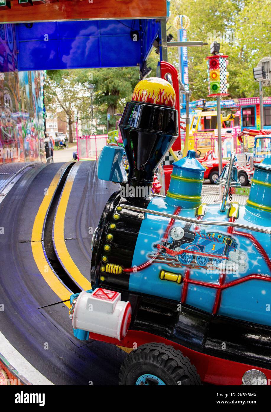 Fairground at Parsons Green, West London, UK; super-bright coloured ...