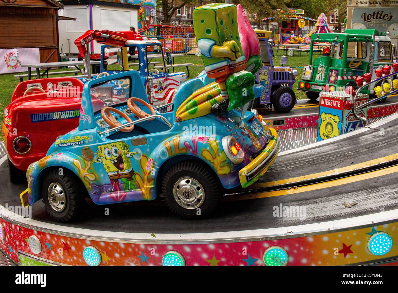 Fairground at Parsons Green, West London, UK; super-bright coloured ...