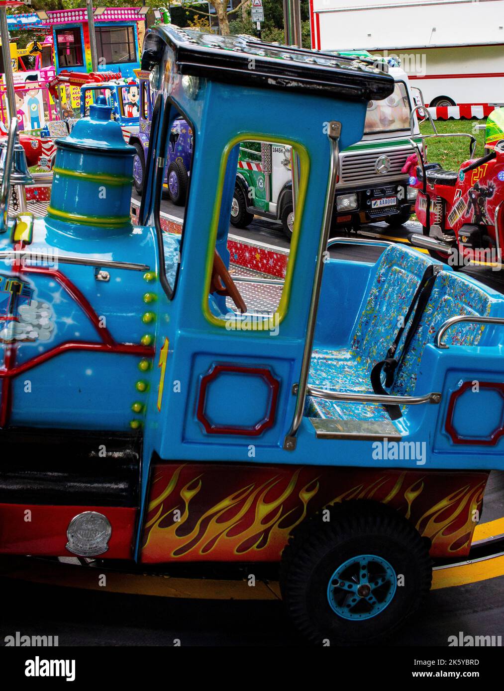 Fairground at Parsons Green, West London, UK; super-bright coloured ...