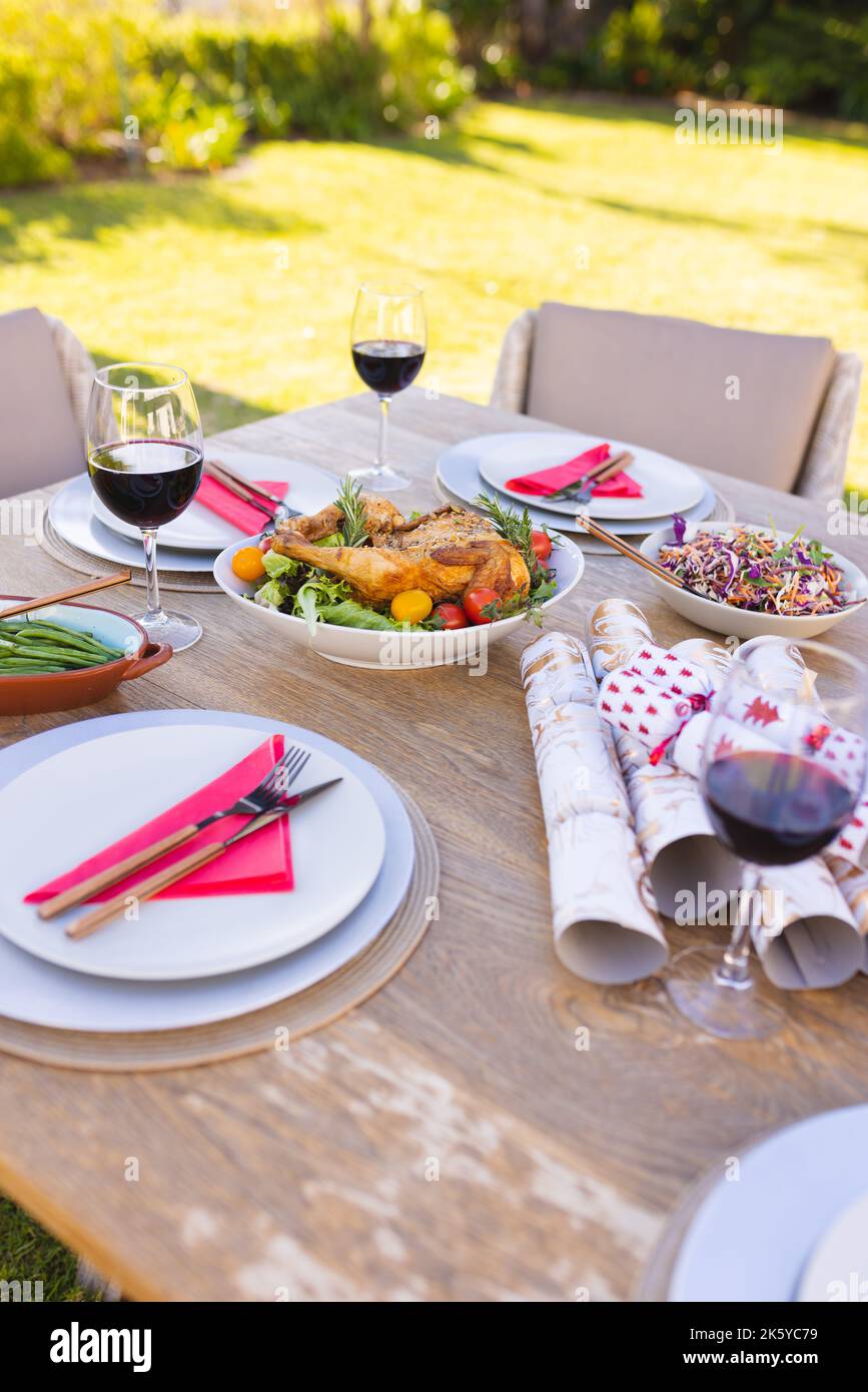 Vertical picture of a wooden table prepared for a meal in the sunny ...