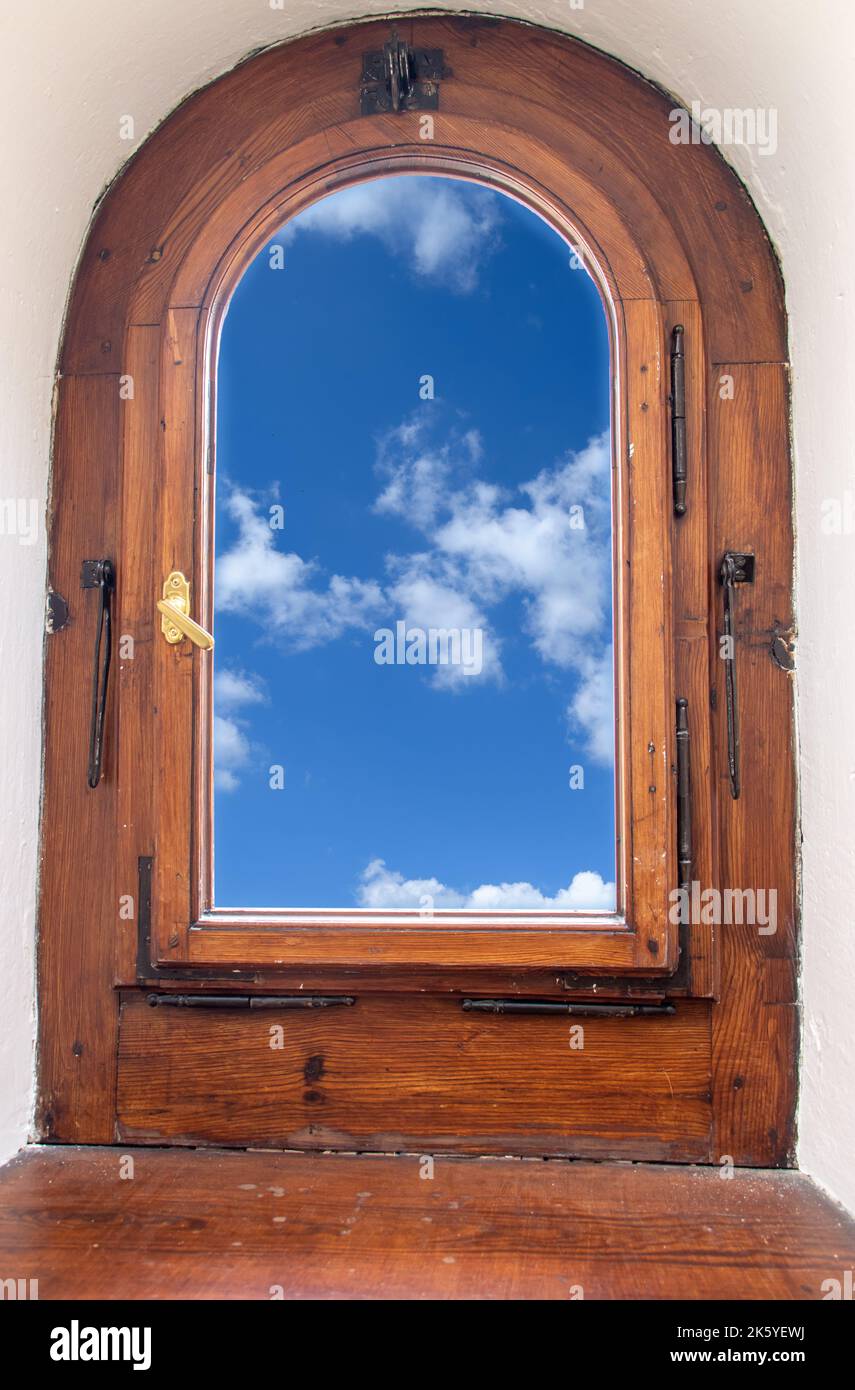 A view of the summer sky through an arched window Stock Photo - Alamy