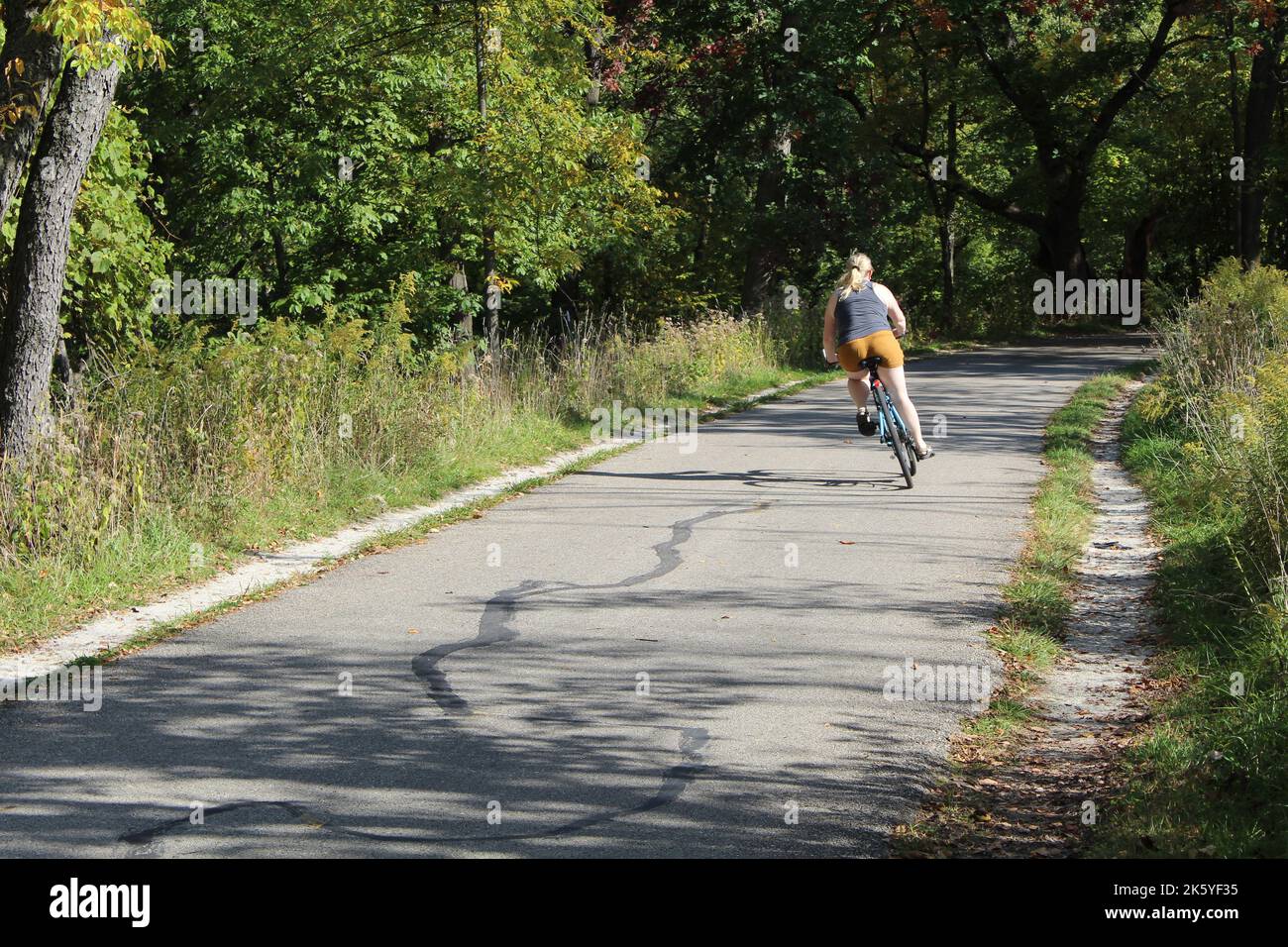 Woman swerving on her bicycle on the North Branch Trail in Morton Grove ...