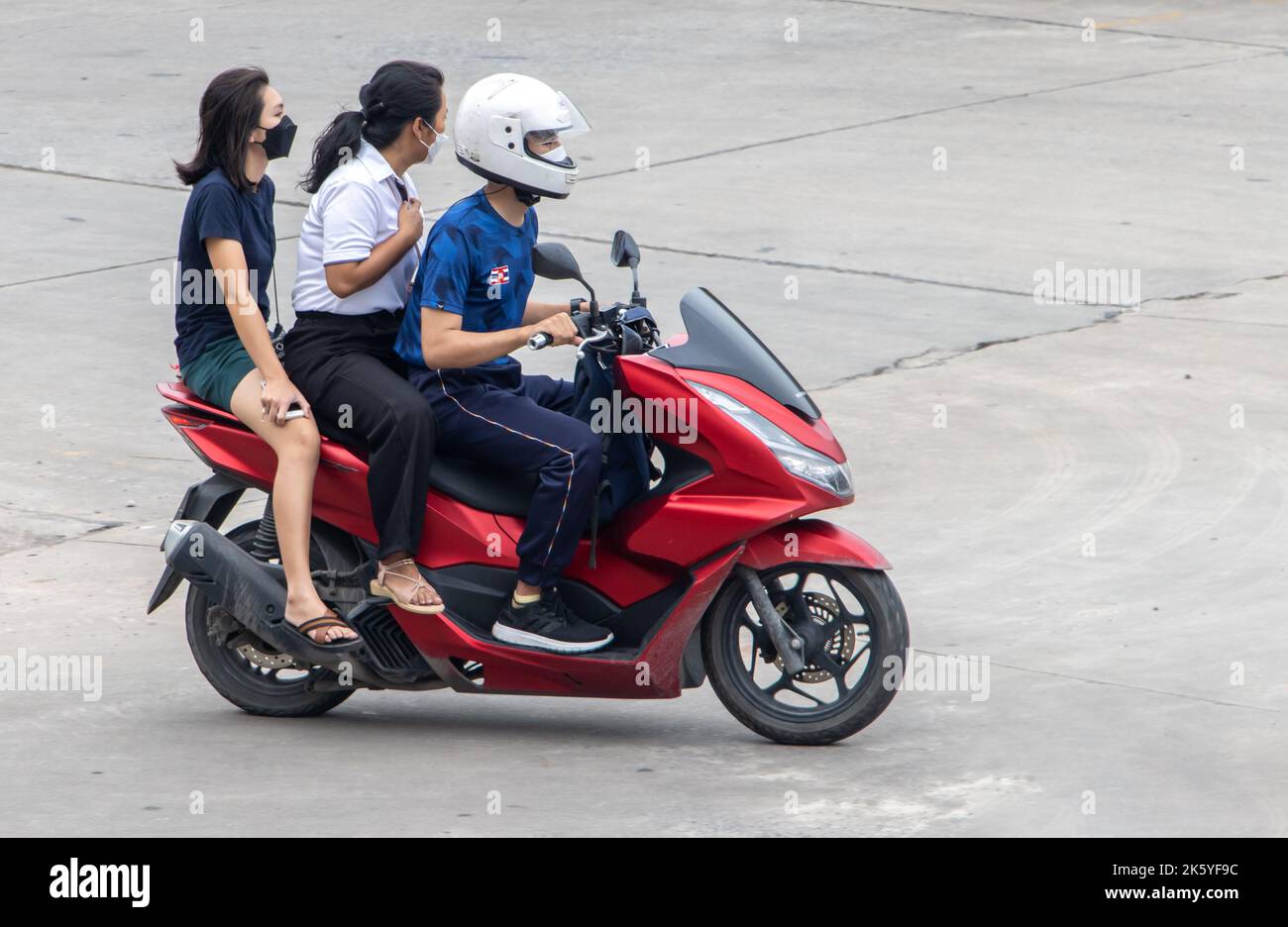 Three people on one motorbike hi-res stock photography and images - Alamy