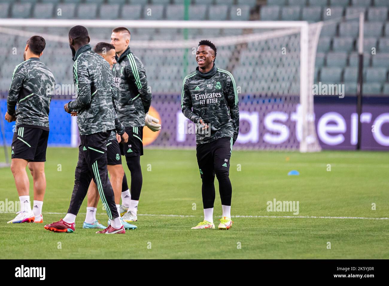 Vinicius Junior (R) of Real Madrid smiles during the official training ...